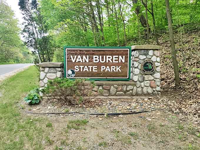 The park's entrance sign promises adventures that deliver far more than the modest wooden letters could possibly suggest.