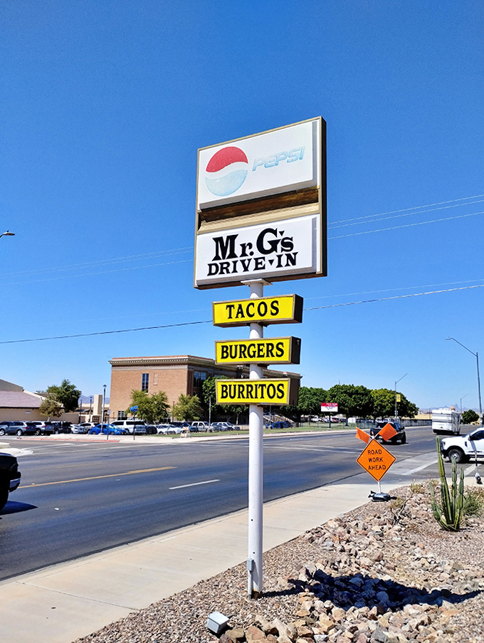 A beacon for hungry travelers, this classic sign promises three essentials of happiness – tacos, burgers, and burritos – available just steps away.