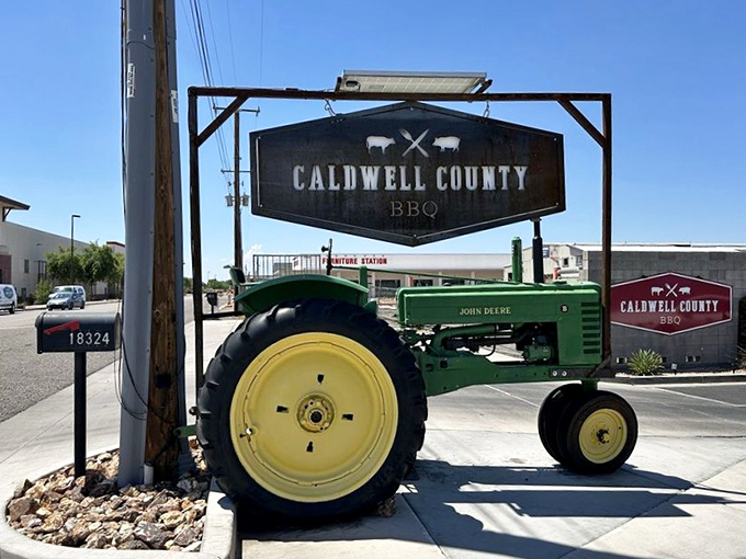 A vintage John Deere tractor guards the entrance &ndash; because nothing says "serious barbecue ahead" quite like agricultural equipment from yesteryear.