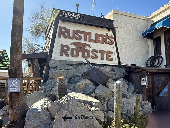 The entrance sign, nestled among desert rocks and cacti, welcomes hungry travelers – your first hint that this isn't your ordinary steakhouse experience.