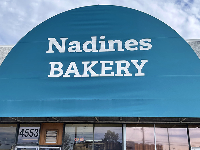 The signature turquoise sign against the Arizona sky &ndash; a landmark for Tucson locals who know that true baking artistry awaits inside.