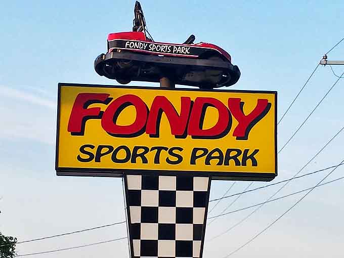 The iconic Fondy Sports Park sign welcomes families to a day of competitive bonding. Many enter as polite relatives and leave as trash-talking champions with soaked socks.