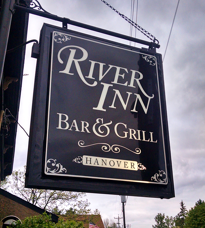 The iconic sign stands as a beacon for hungry travelers, promising satisfaction just beyond its black and white elegance.