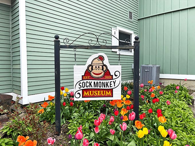 Colorful tulips frame the museum's sign, creating a picturesque welcome that hints at the whimsy waiting inside.