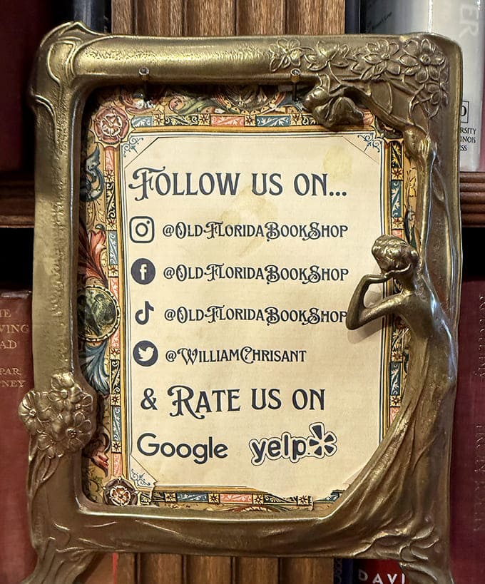A vintage frame announces the shop's social media presence, blending old-world charm with modern connectivity in perfect literary harmony.