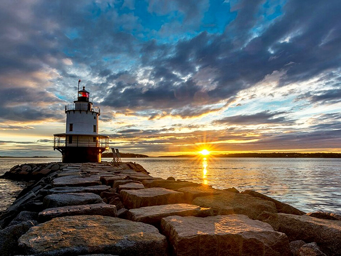 Golden hour transforms the lighthouse into a silhouette against the setting sun, creating the kind of moment that makes amateur photographers look professional.