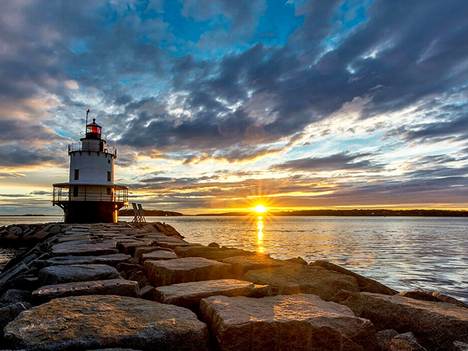 Golden hour bathes the lighthouse in amber light, creating that magical moment photographers chase and rarely capture.