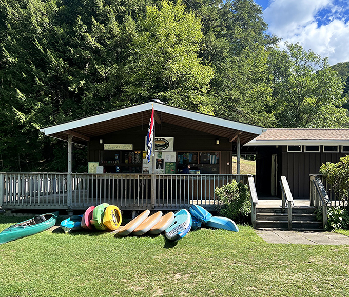 Kayaks lined up like colorful soldiers ready to explore every corner of this emerald gem hidden in Vermont's mountains.