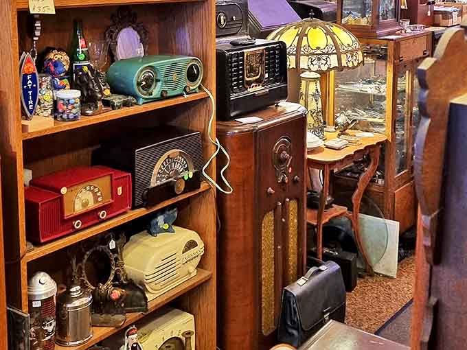 Colorful vintage radios line the shelves, back when listening to music meant gathering around a piece of furniture.