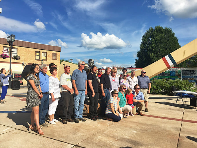 Proud visitors gather beneath the towering tribute to hockey &ndash; united by their appreciation for oversized attractions and the community spirit they represent.