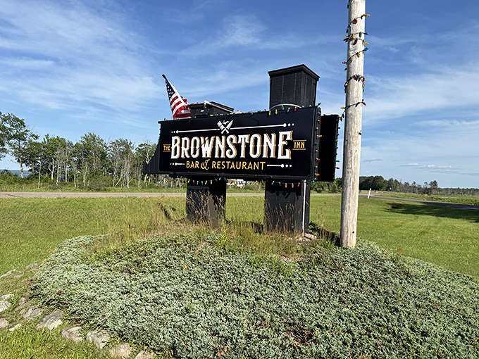 The Brownstone Inn sign doesn't just mark a location&mdash;it's a beacon for hungry travelers, promising culinary salvation in the Upper Peninsula wilderness.