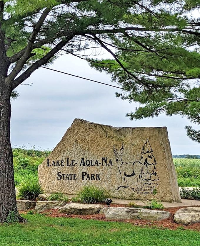 The park's impressive entrance marker stands as both welcome and promise &ndash; beyond this stone lies adventure waiting to be discovered.