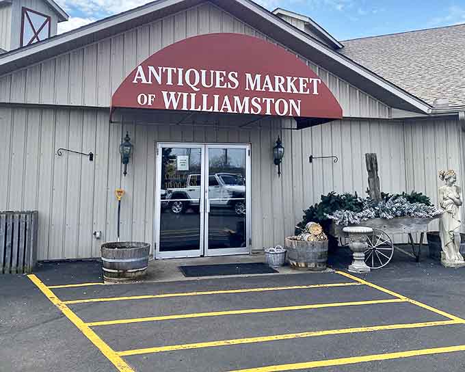 The market's entrance promises adventure, with its distinctive barn-like structure and burgundy awning beckoning treasure hunters from near and far.