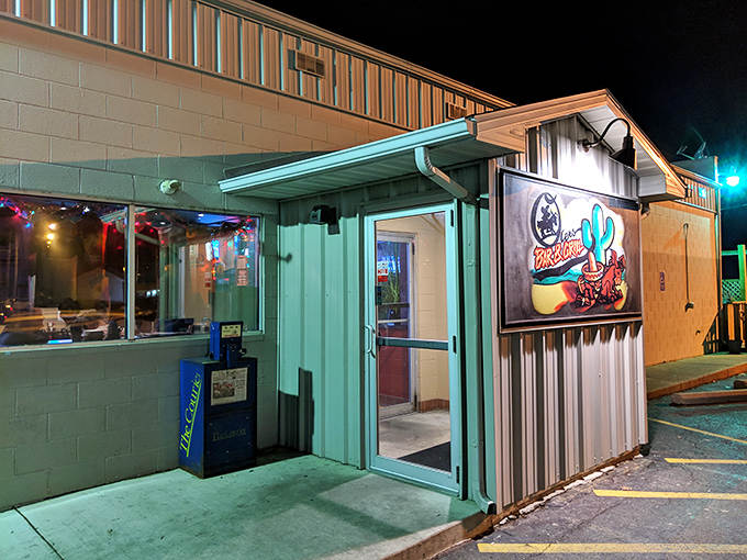 The gateway to barbecue nirvana, where the neon glow promises delicious adventures await just beyond these doors.