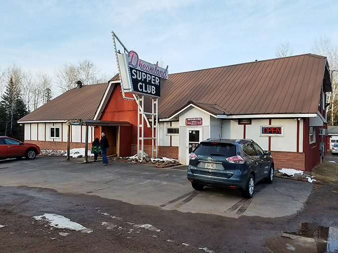 Dreamland Supper Club's iconic neon sign glows against the Wisconsin sky, beckoning hungry travelers with promises of classic supper club magic.