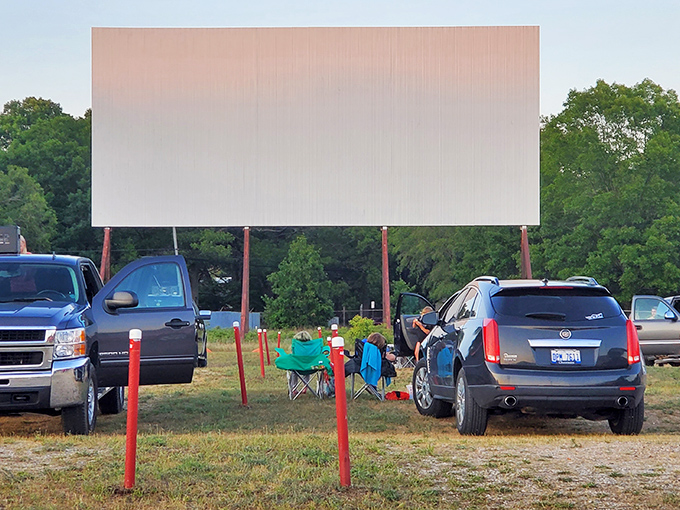 Cars line up facing the giant white screen at Getty Drive-In, where modern vehicles create new memories in a classic setting.