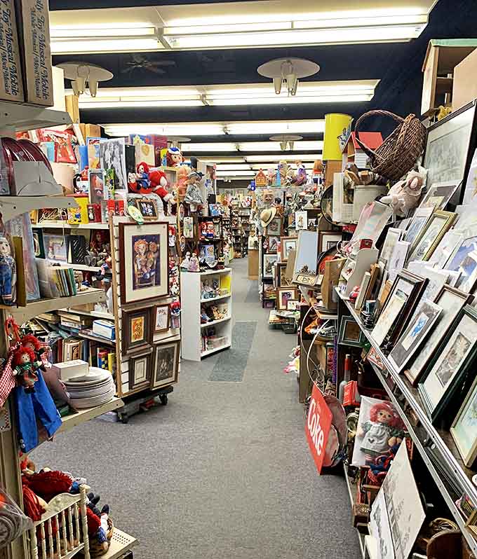 Stepping inside reveals a labyrinth of memories where narrow aisles create canyons of collectibles stretching impossibly far, defying the building's exterior dimensions.