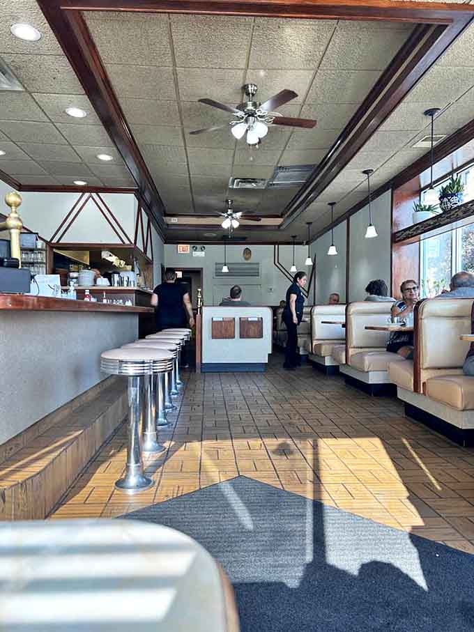 Classic diner aesthetics reign supreme inside Alexander's &ndash; chrome-trimmed counter, vinyl booths, and ceiling fans spinning stories of four decades serving Chicago's comfort food aficionados.