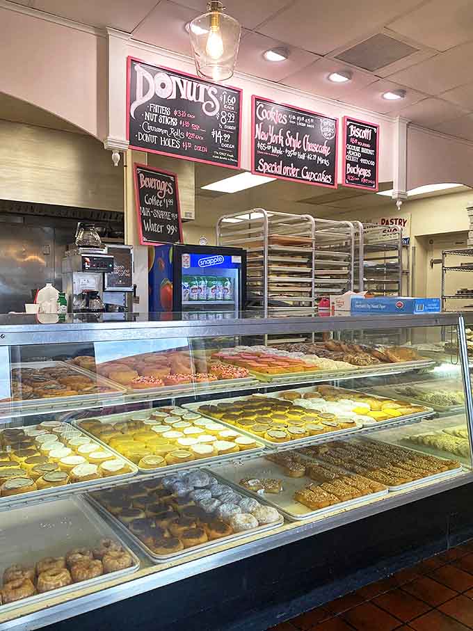 Behind the counter, a tempting array of donuts awaits early birds. The handwritten menu board showcases daily offerings with charming simplicity.