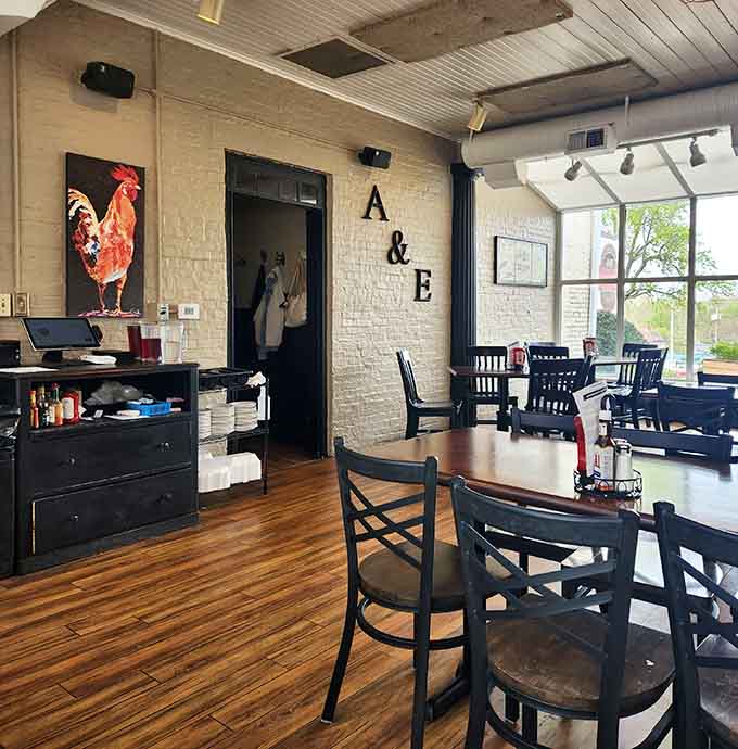 Warm wood floors and painted brick walls create an inviting atmosphere that's both modern and comfortable.