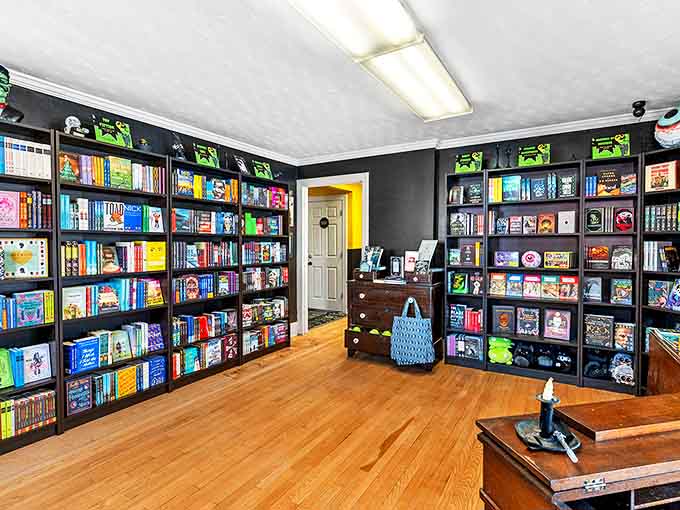 Sophisticated black shelving creates a gallery atmosphere where colorful book spines pop like confetti at a literature lover's celebration.