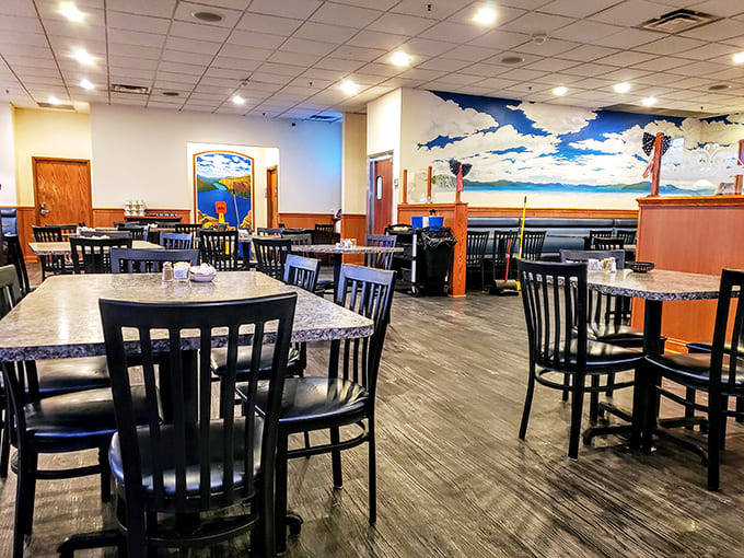 Simple, comfortable dining space where the blue sky mural creates an unexpected touch of whimsy in this no-nonsense eatery.