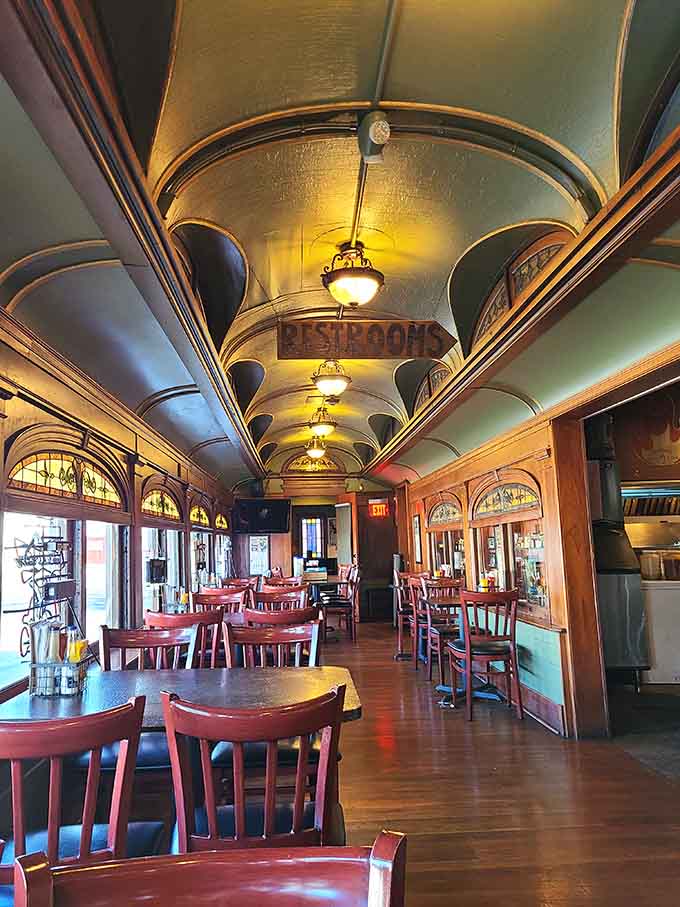 Arched ceilings and warm wood tones create an intimate dining atmosphere inside the vintage presidential train car.