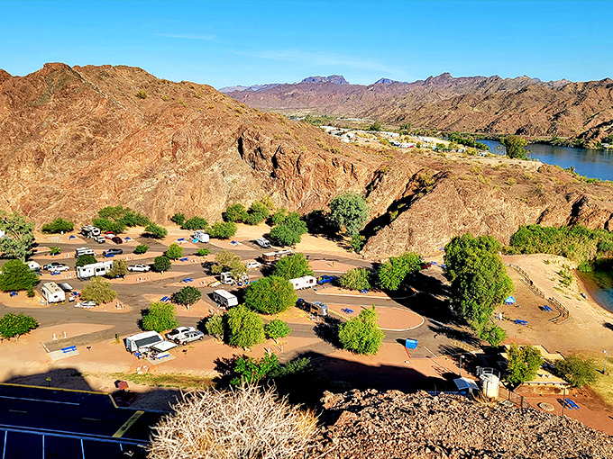 Desert camping reimagined: where RVs nestle between rust-colored mountains and the life-giving Colorado River creates an unforgettable outdoor living room.