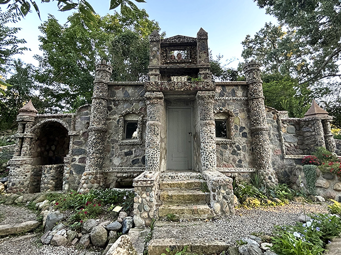 The castle structure rises from the earth like medieval architecture shrunk down to garden gnome proportions, proving that size matters less than dedication and really good stone-balancing skills.