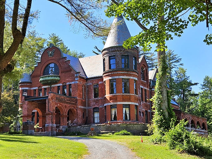 Sunlight bathes the castle's fa&ccedil;ade, highlighting the intricate brickwork and distinctive turrets that have stood watch for over a century.