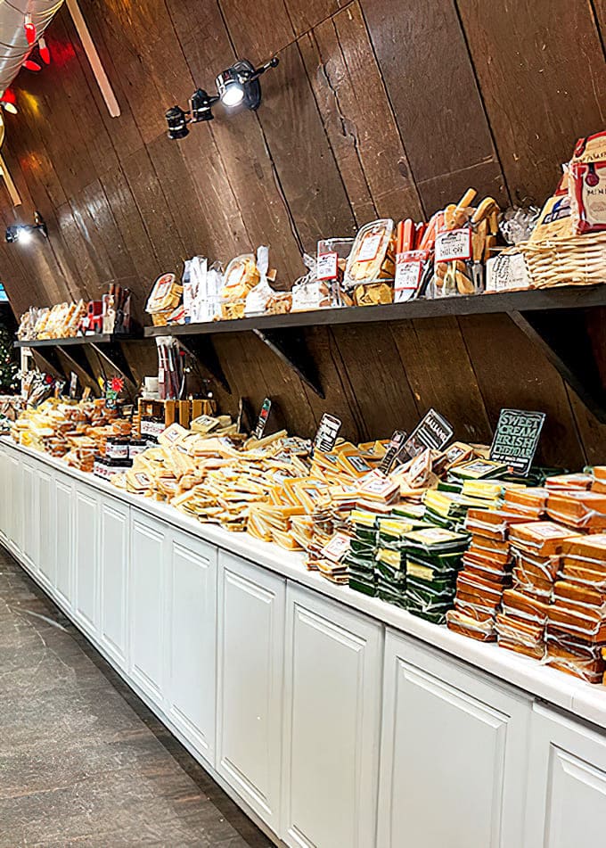 Wooden walls line this cheese wonderland where hundreds of varieties await, arranged with the care usually reserved for fine art exhibitions.