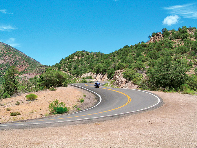 Coronado Trail's serpentine curves hug the mountainside, offering thrill-seekers a rollercoaster ride through some of Arizona's most dramatic terrain.