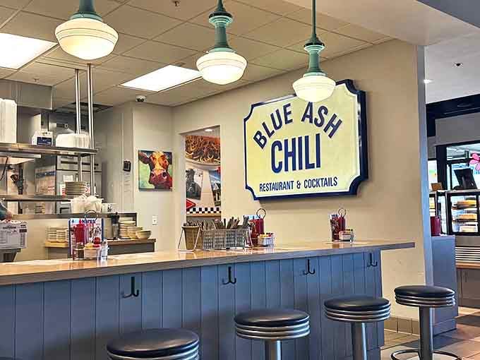 The classic blue-paneled counter invites solo diners to pull up a stool and watch culinary magic happen in real time.