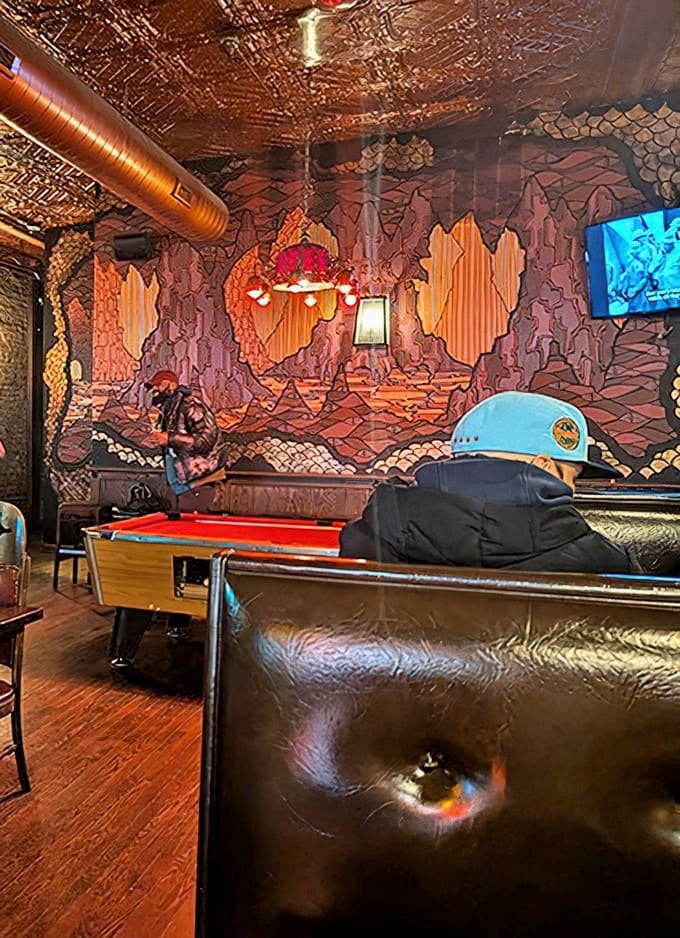 The interior balances dive bar charm with neighborhood comfort &ndash; copper ceiling, exposed brick, and a pool table invite lingering conversations.