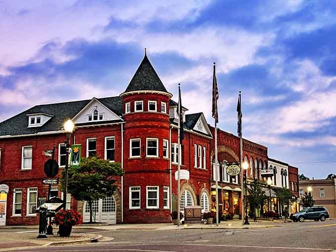 Twilight transforms downtown Holly into a magical scene, with the iconic turret building standing sentinel over streets lined with independent shops.