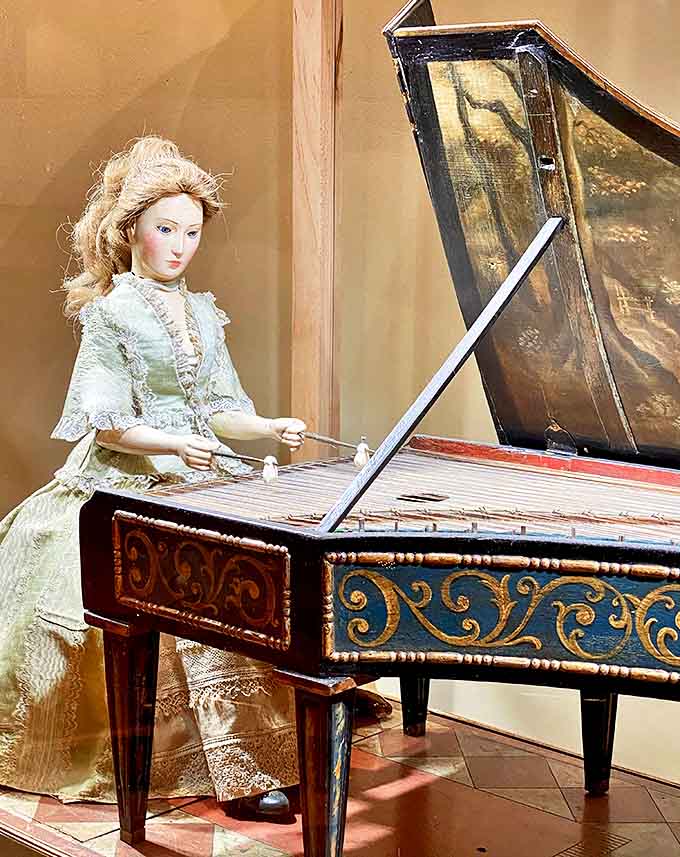 This 18th-century automaton dulcimer player demonstrates the marriage of music and mechanics, her delicate fingers poised to strike notes that have echoed through centuries.