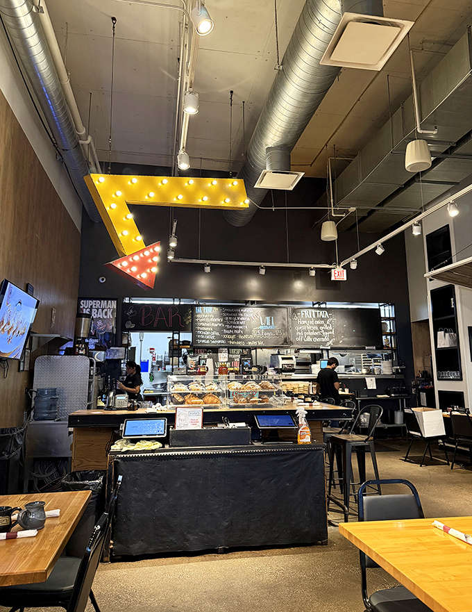 Industrial chic meets diner comfort in this space where exposed ductwork and warm wood create the perfect breakfast atmosphere.