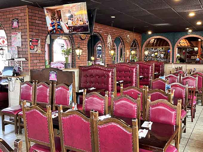 Those burgundy throne-like chairs and brick archways create an atmosphere that's both festive and surprisingly intimate for your enchilada adventure.