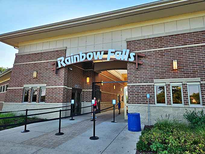The entrance to Rainbow Falls beckons like a portal to paradise, where the only dress code is swimwear and good vibes.