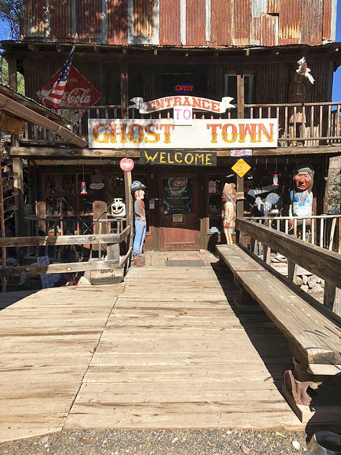 The weathered wooden entrance beckons visitors with its "GHOST TOWN" sign and Coca-Cola memorabilia &ndash; your portal to Arizona's mining past.