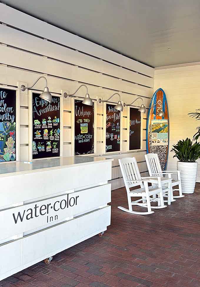First impressions matter: The welcoming entrance of WaterColor Inn sets the tone with coastal charm and those inviting rocking chairs.