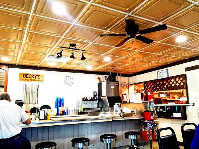 Golden ceiling tiles gleam above the counter where locals gather, creating that perfect small-town diner atmosphere where everyone feels instantly at home.