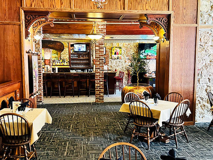 Exposed brick columns frame the dining room like a rustic Italian postcard, where history and hospitality blend seamlessly.