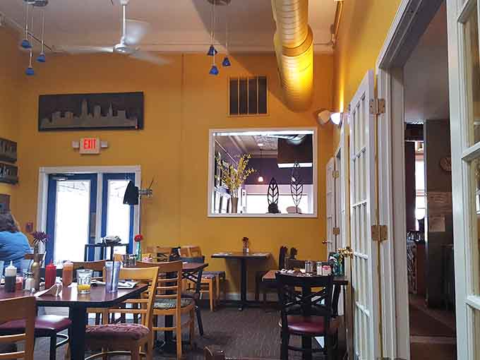 Sunny yellow walls and local artwork create the perfect backdrop for serious eating, where comfort meets creativity in every corner.
