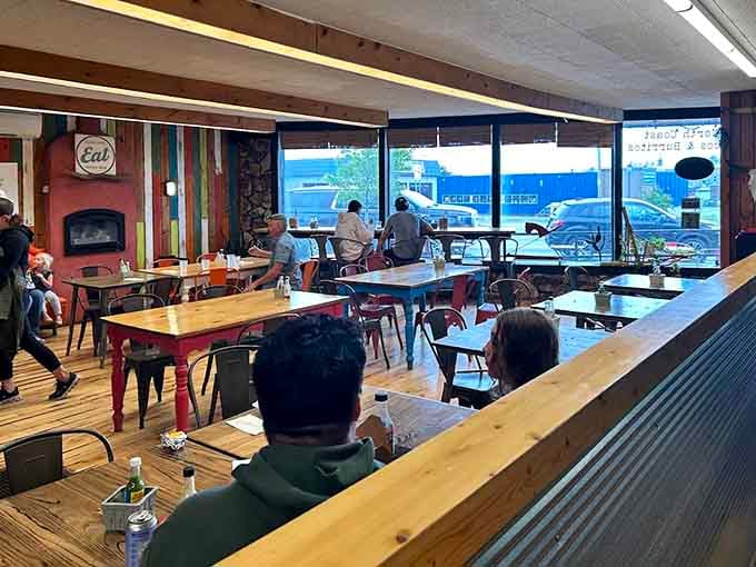 Inside, mismatched tables and colorful decor create a laid-back atmosphere where everyone feels like a regular from day one.