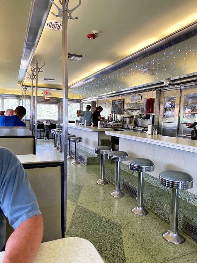 The counter where breakfast dreams come true – chrome stools await patrons while staff orchestrate the morning symphony of sizzles and clinks.