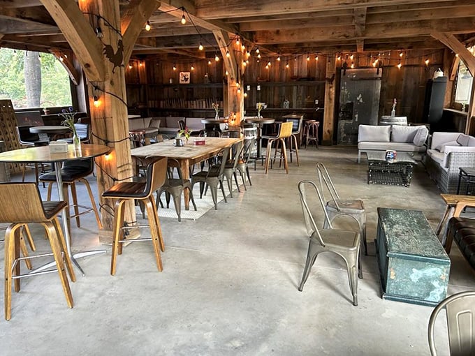Rustic elegance meets cozy comfort in this converted barn space, where string lights and wooden beams create an atmosphere that's both magical and welcoming.