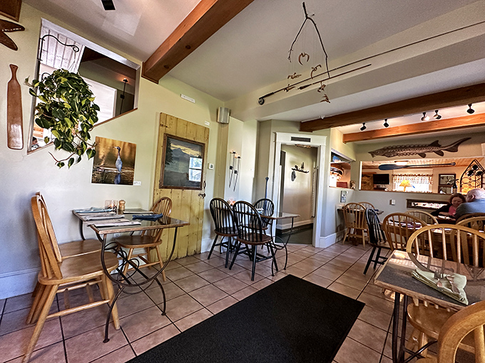 Rustic wooden beams meet comfortable elegance in this dining room where every table feels like the best seat in the house.
