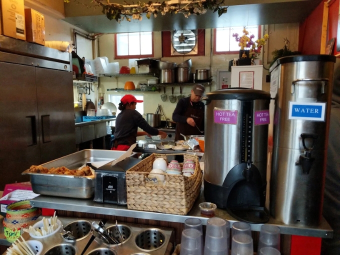 A glimpse into the compact kitchen where culinary magic happens, where aromatic Thai spices transform Vermont ingredients into transcendent dishes.