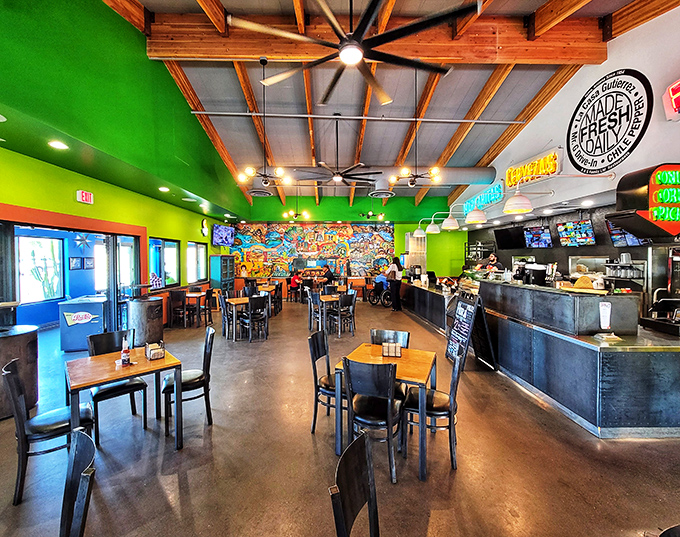 Vibrant green walls and exposed wooden beams create a festive atmosphere where taco dreams come true. The ceiling fans keep things cool while flavors heat up.